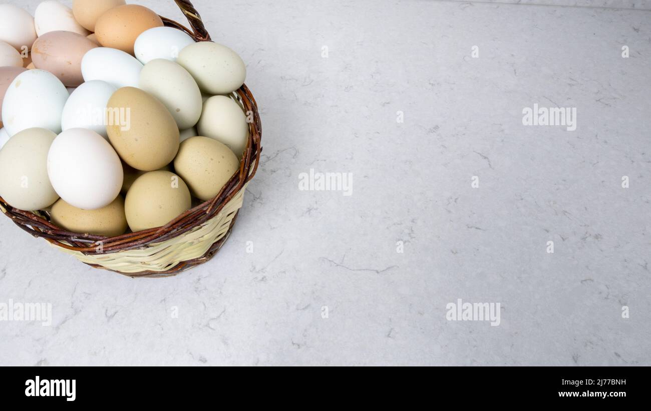 Free-Range Eggs in different colors are in a basket Stock Photo - Alamy