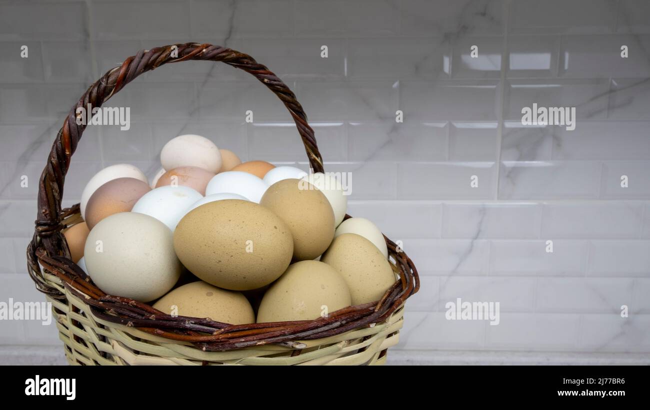 Free-Range Eggs in different colors are in a basket Stock Photo - Alamy