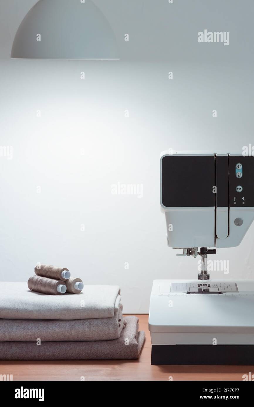 Tailor's desk, sewing machine and lighting Stock Photo - Alamy