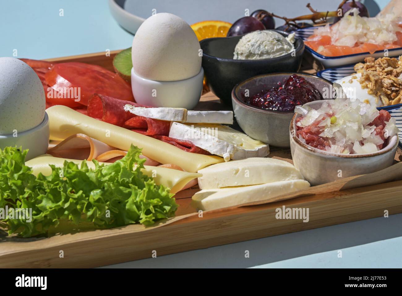 Breakfast or lunch buffet on a tray with various cold cuts, cheese ...