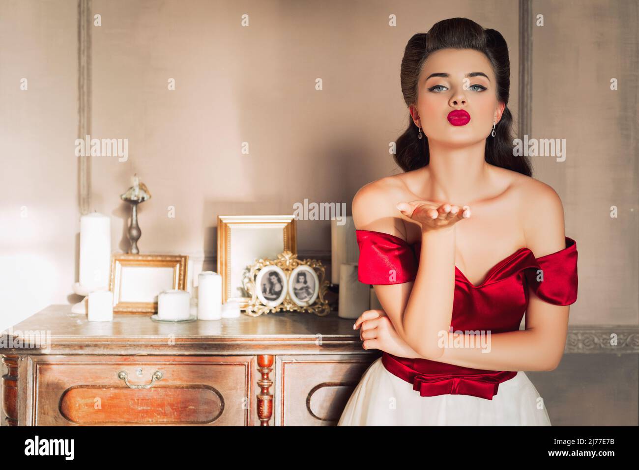 Beautiful flirtatious girl as a pin up model in dress in retro interior. Jailbait concept ...