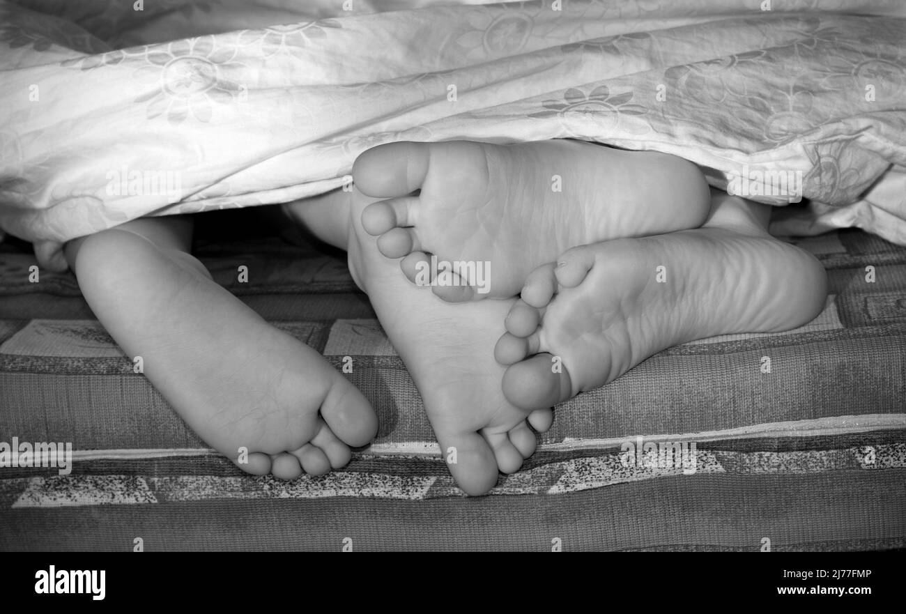 The feet of sisters in the morning light Stock Photo - Alamy