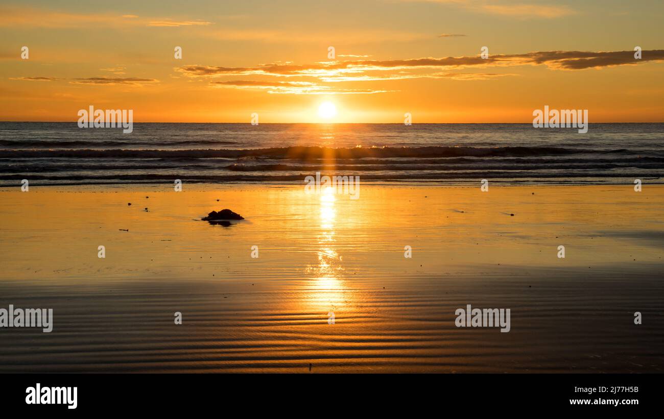 Sunrise at Long Beach near Dunedin Stock Photo - Alamy