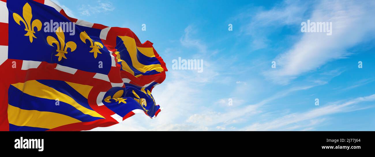 flag of Bourgogne, France at cloudy sky background on sunset, panoramic view. French travel and ...