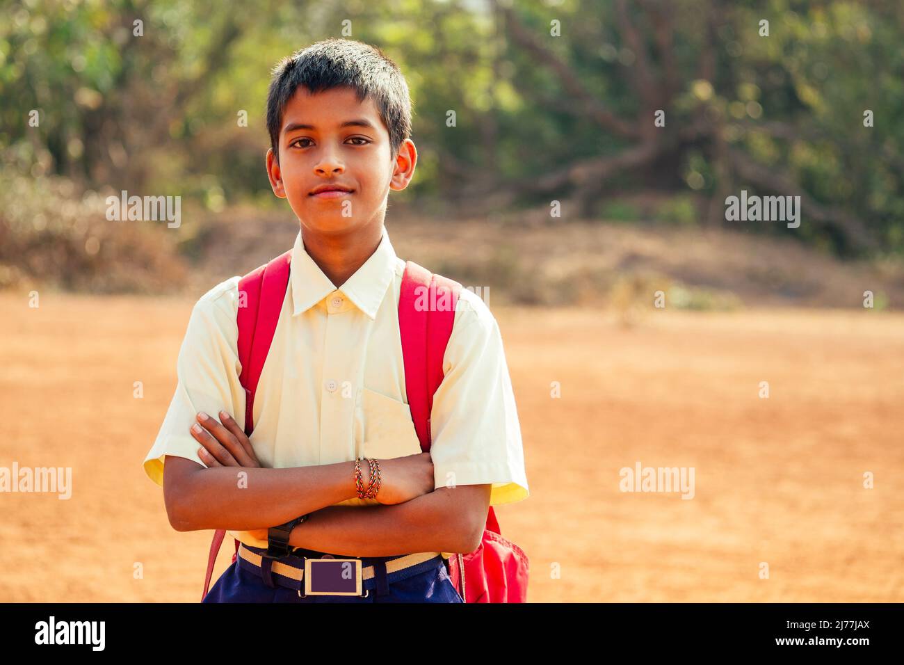 indian smart boy arms crossed looking at camera in backyard Stock Photo ...