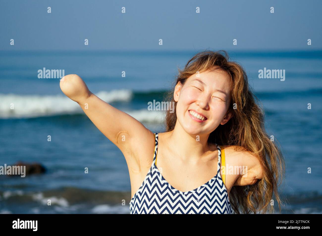 happy asian armless woman smilimg at the tropical beach Stock Photo - Alamy