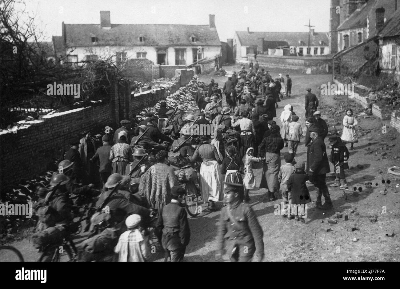 A line of troops, fully armed and equipped, are walking through a ...
