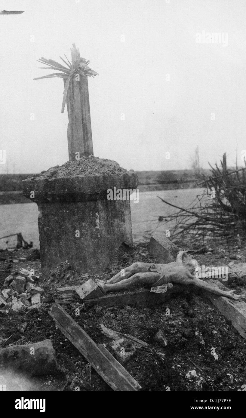 A shattered crucifix ina destroyed church yard on the Western Front in ...