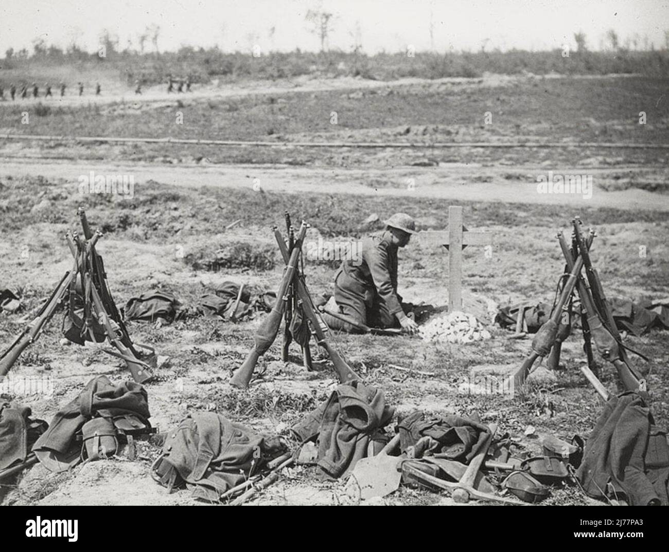 A soldier tending a grave of a dead comrade on the Western Front during ...