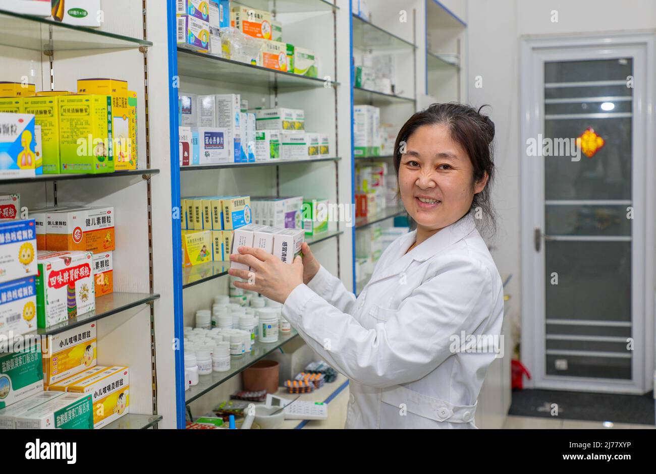 TENGZHOU, CHINA - MAY 6, 2022 - A worker smiles as she arranges ...
