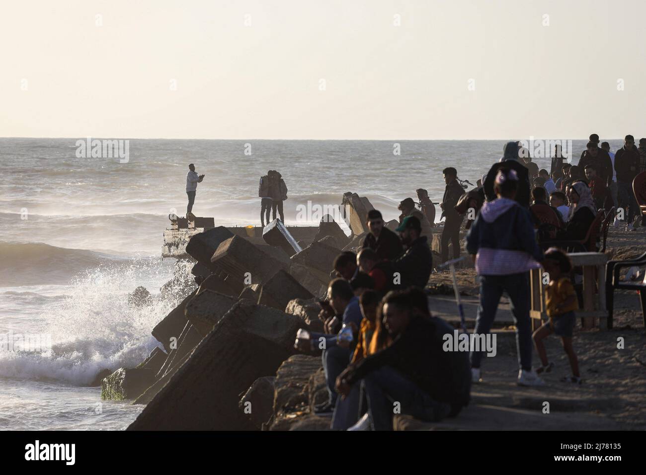 Palestinians enjoy the sun and the warm weather at the Gaza beach on ...
