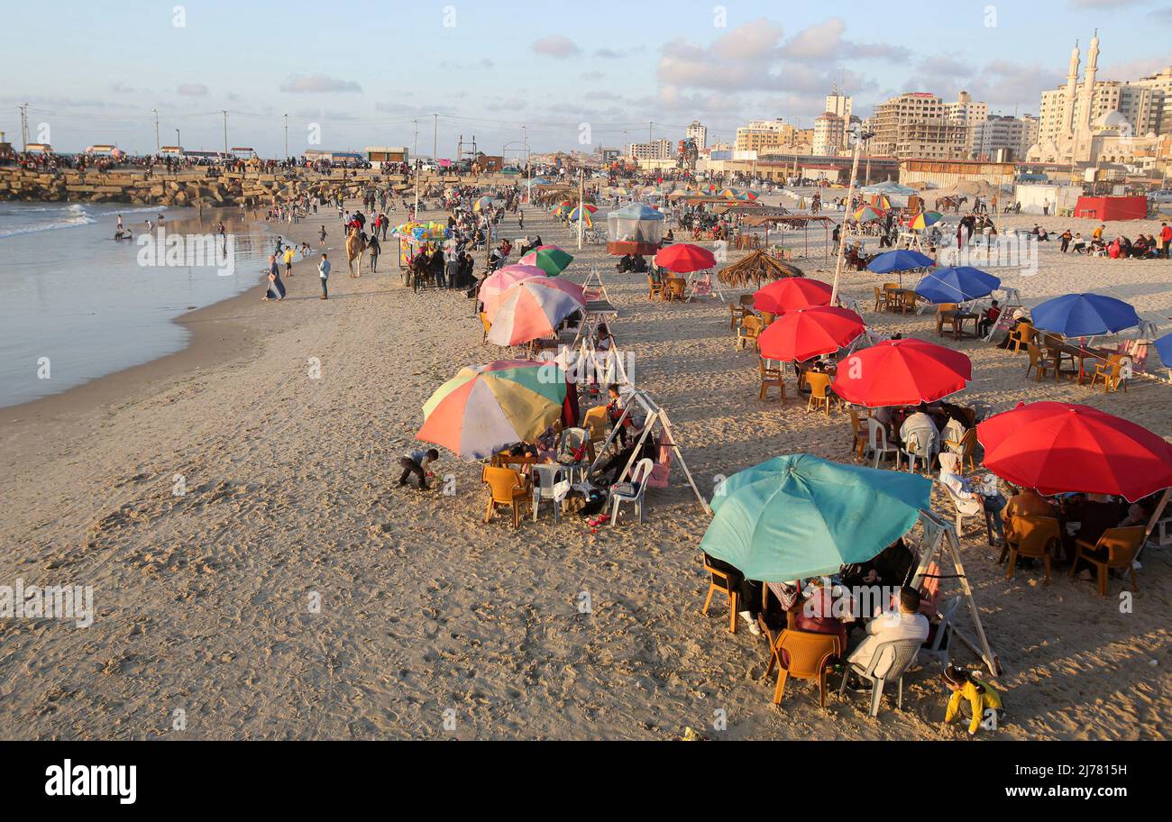 Palestinians enjoy the sun and the warm weather at the Gaza beach on ...