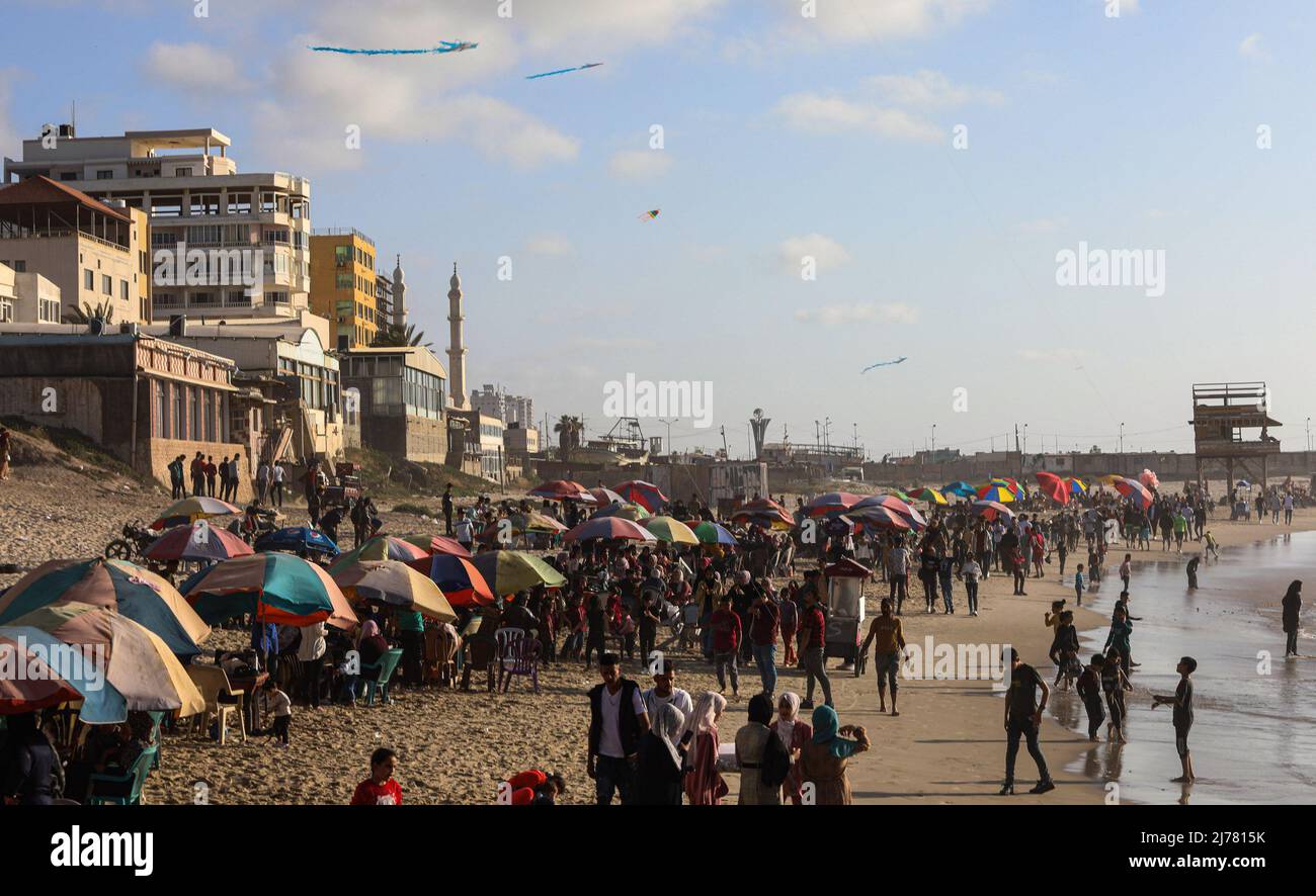 Palestinians enjoy the sun and the warm weather at the Gaza beach on ...