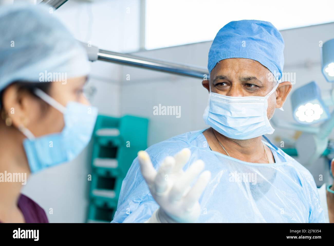 close up shot of surgeon busy operating surgery with support staff or ...