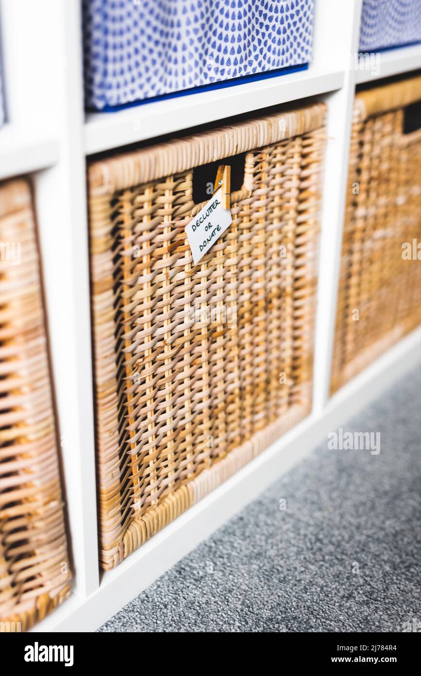 basket with Declutter or Donate label on it with unfocused storage ...