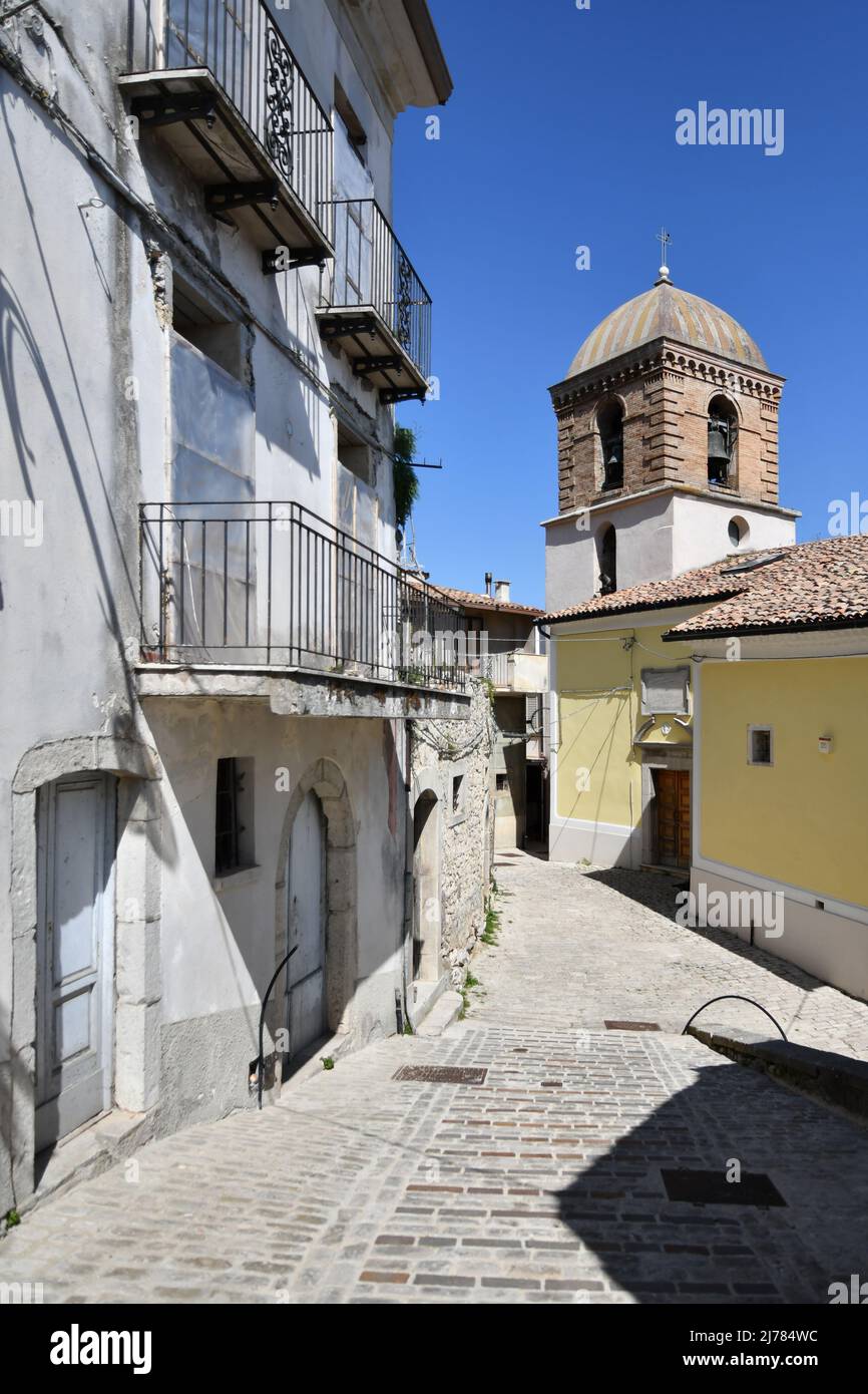 A narrow street between the old houses of Morcone, a village in the ...