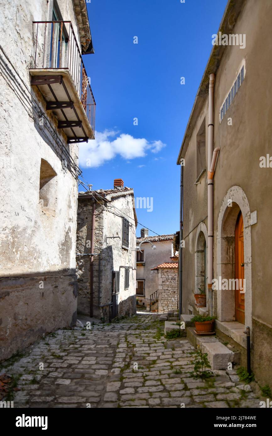 A narrow street between the old houses of Morcone, a village in the ...