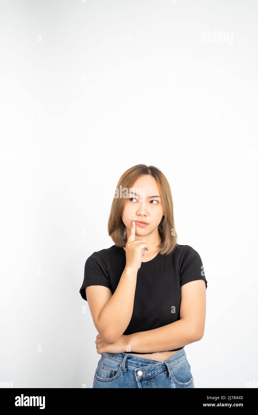 Thoughtful Asian woman poses against isolated background Stock Photo ...