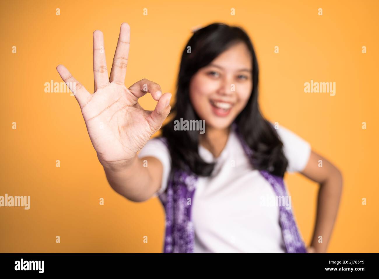 woman smiling with okay hand gesture on isolated background Stock Photo ...