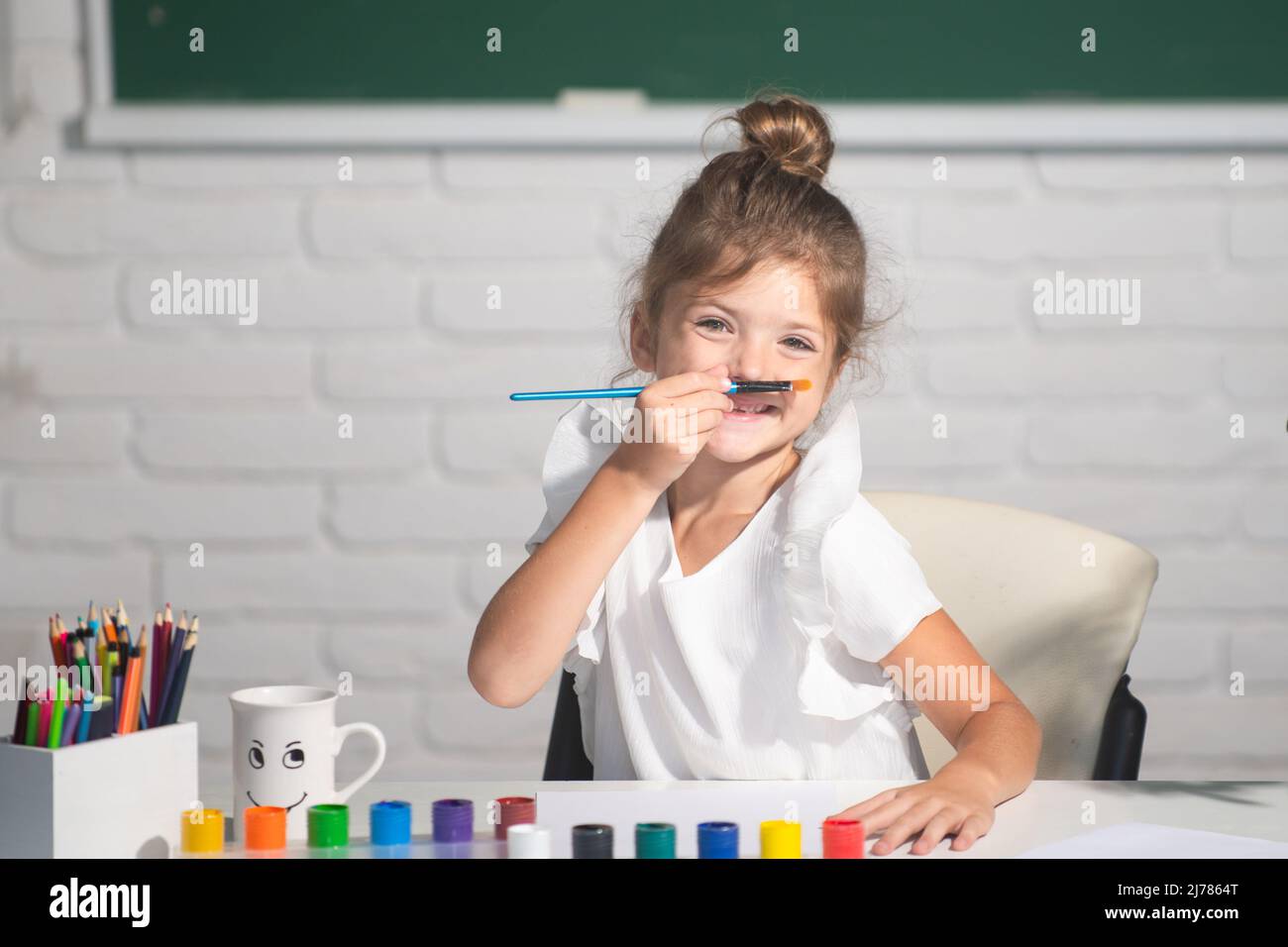 Child girl drawing with coloring pens paintind. Portrait of adorable ...