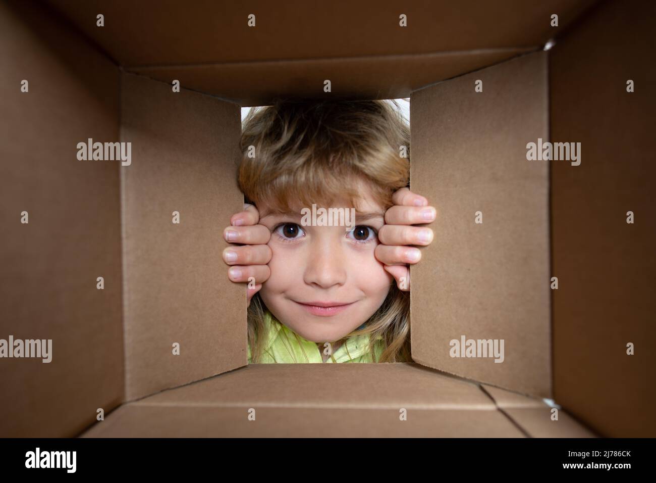Child open paper cardboard box. Kid boy unpacking and opening carton ...