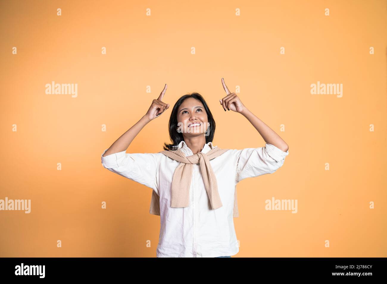 woman with finger pointing up hand gesture on isolated background Stock ...