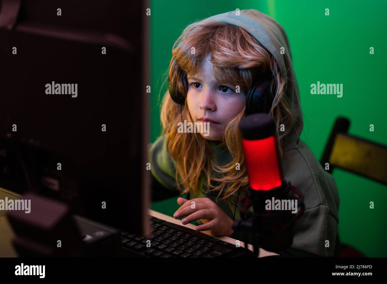 Cute preschool child watching video lesson by laptop. Little child ...