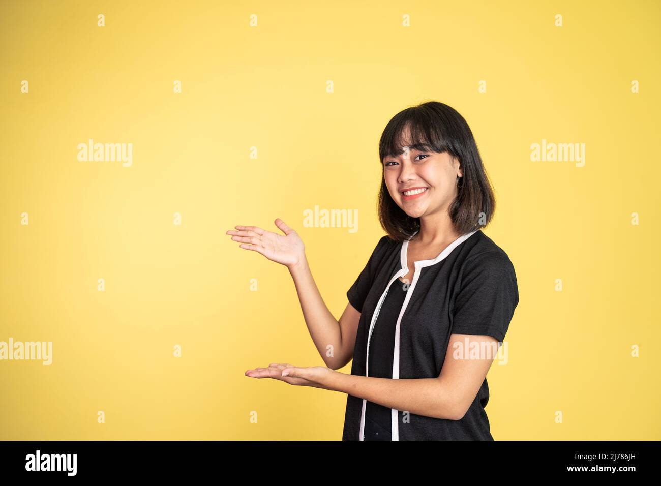 Asian girl with hand gesture presenting something on isolated Stock ...
