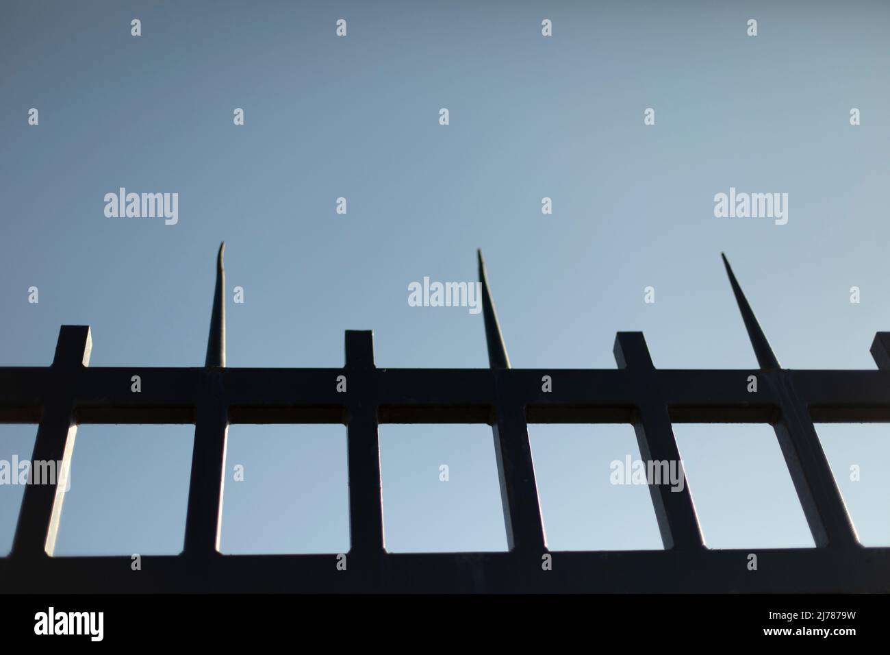 Sharp fence. Steel fence with tips. Blades on fence Stock Photo - Alamy