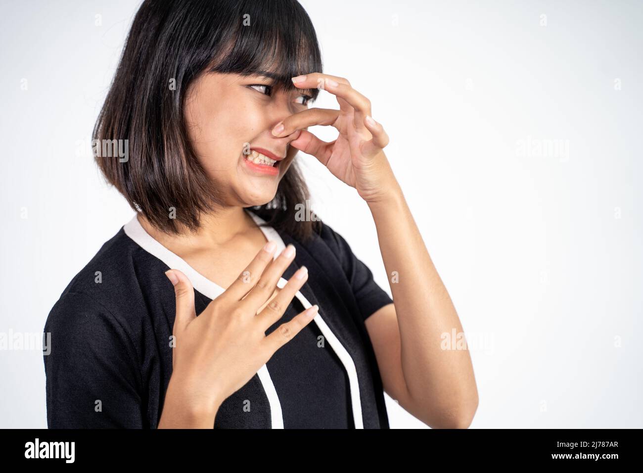 woman covering nose with finger when bad smell Stock Photo - Alamy