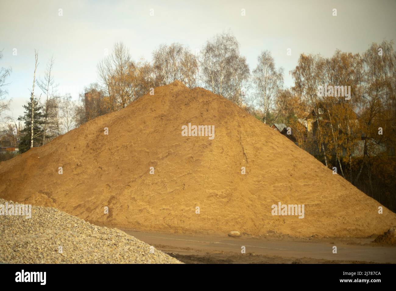 Mountain of sand. Building material. Mound of sand outside ...