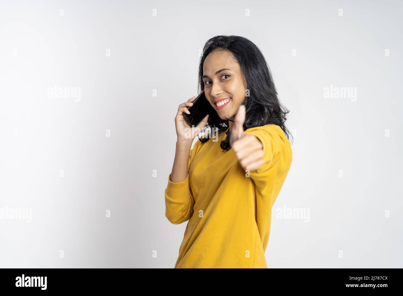 woman stand with thumbs up on isolated background Stock Photo - Alamy