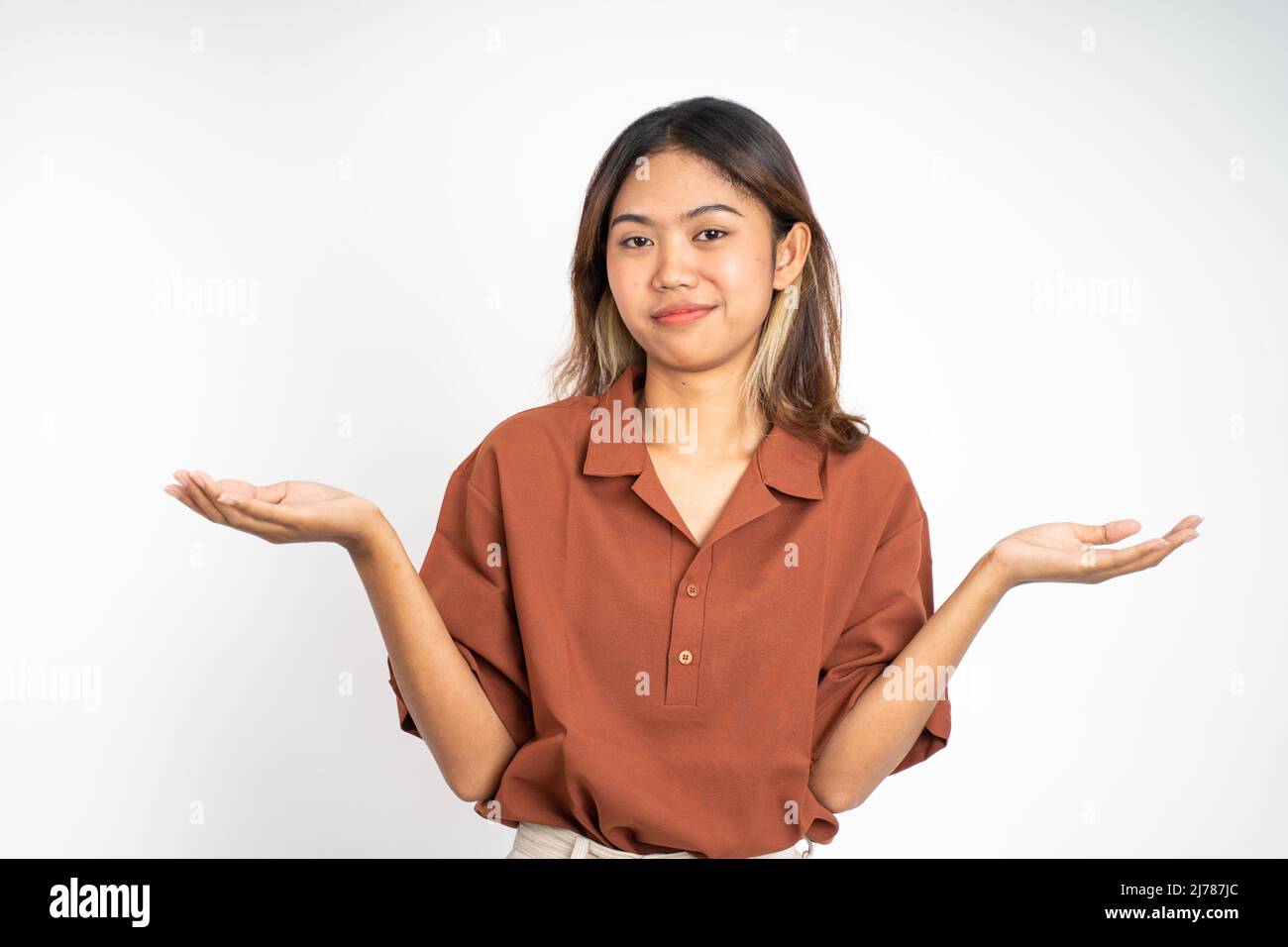 asian woman opening two palms feeling uncertain Stock Photo - Alamy