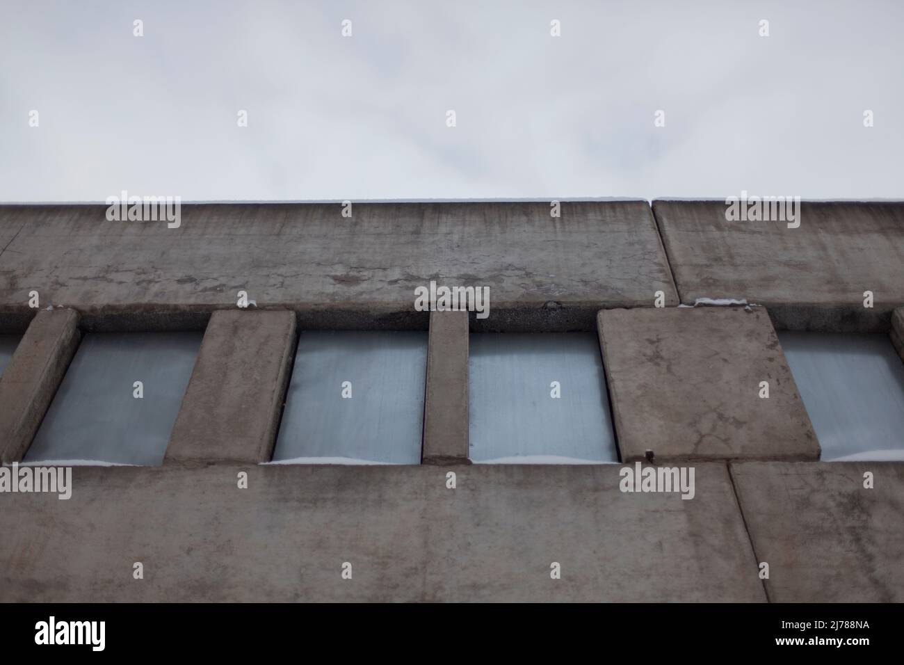 Abandoned building. Windows are tightly sealed with steel sheet. Locked ...