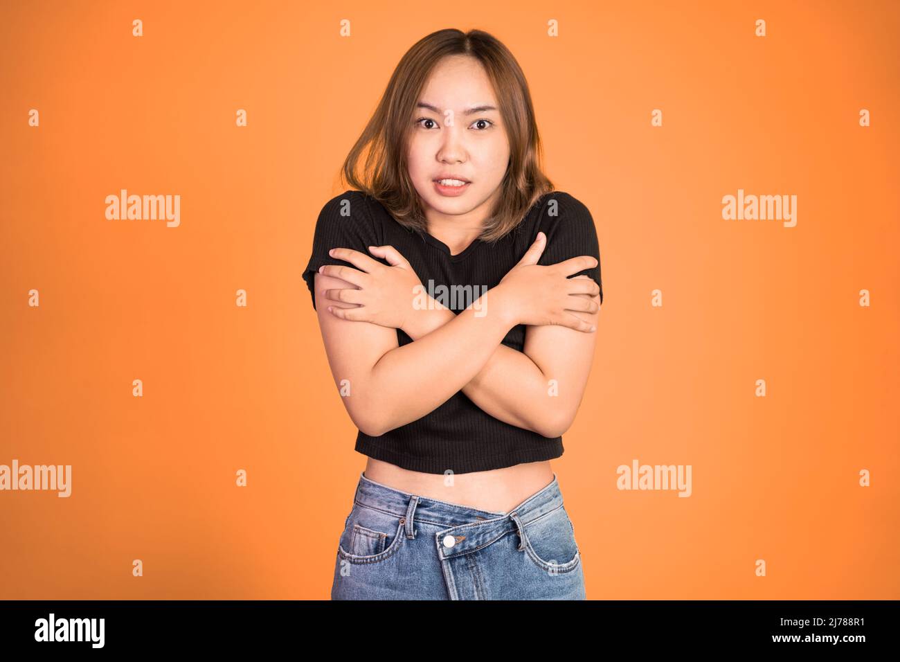 woman feeling cold with both hands hugging her arms Stock Photo - Alamy
