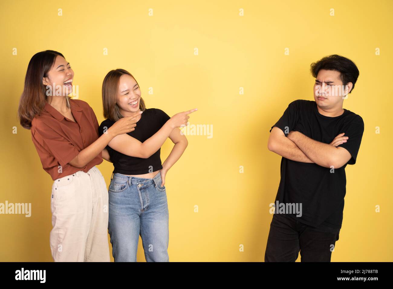 woman pointing finger laughs at sad man on isolated background Stock ...