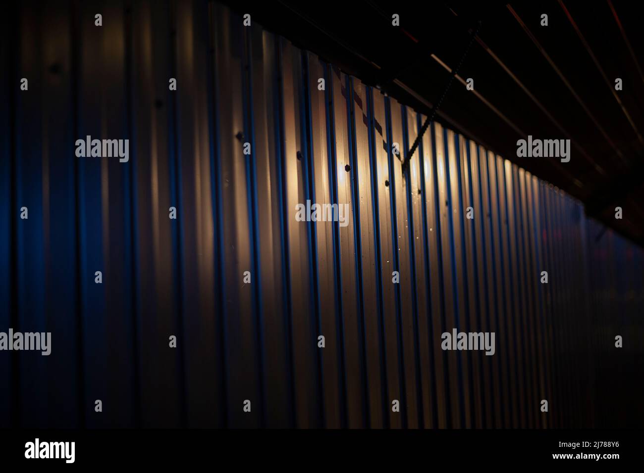 Fence at night. Fencing of territory. Barrier is made of metal profile ...