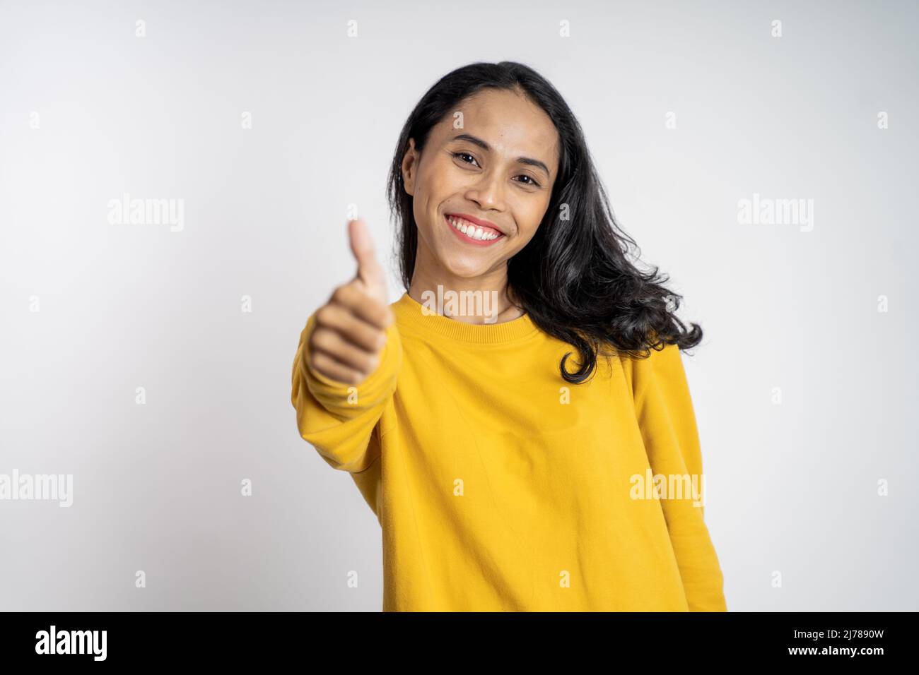 woman stand with thumbs up on isolated background Stock Photo - Alamy