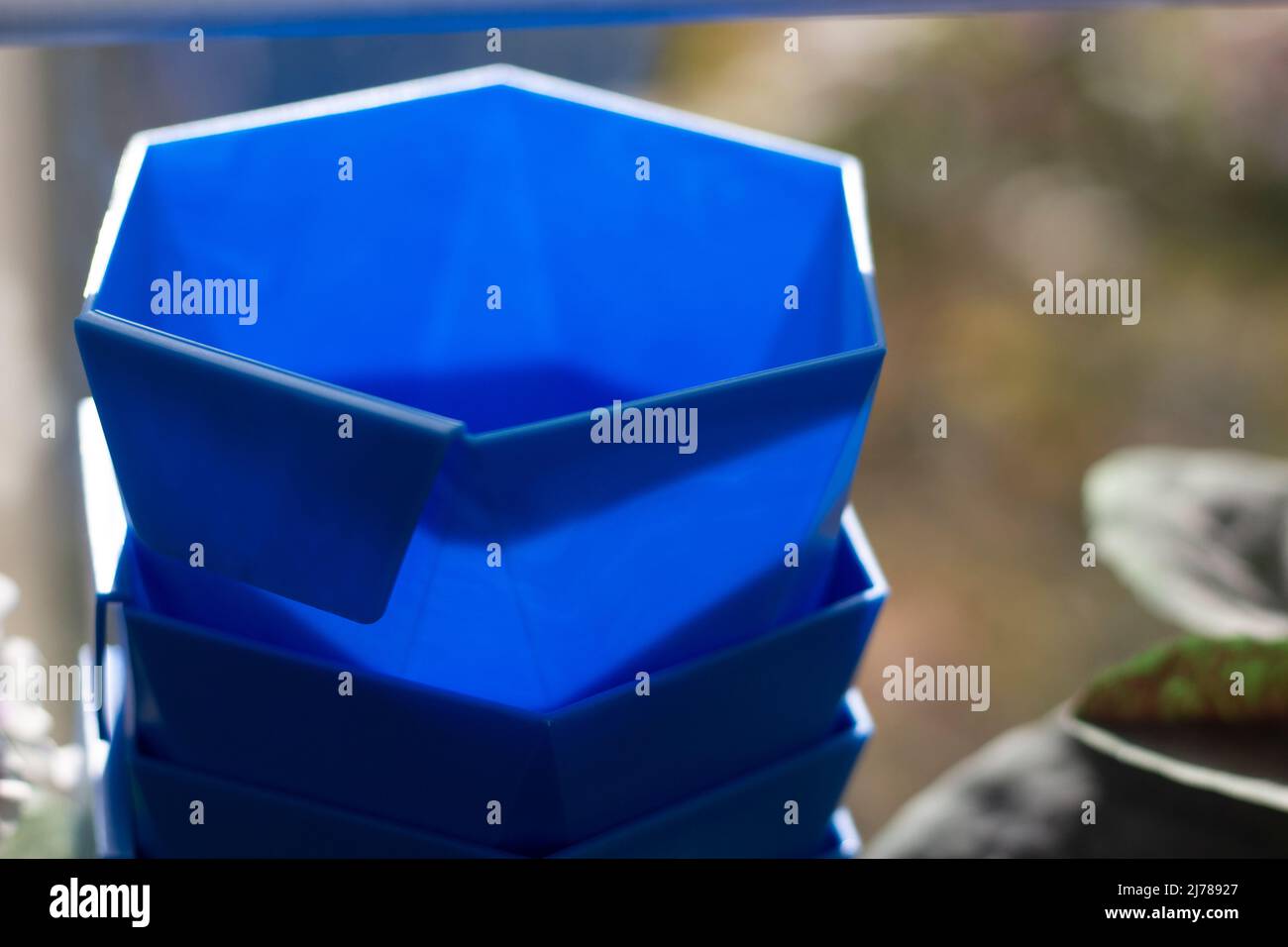 Blue flower pots. Object for growing plant. Sunlight falls on blue ...