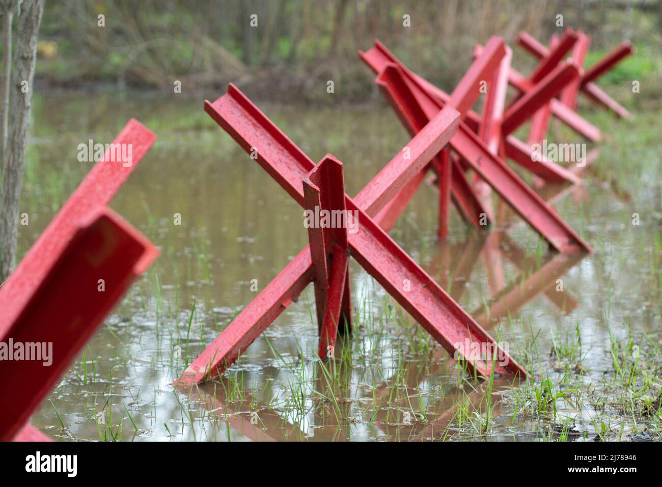 Anti-tank crosses are in the water. Barrage from military equipment ...