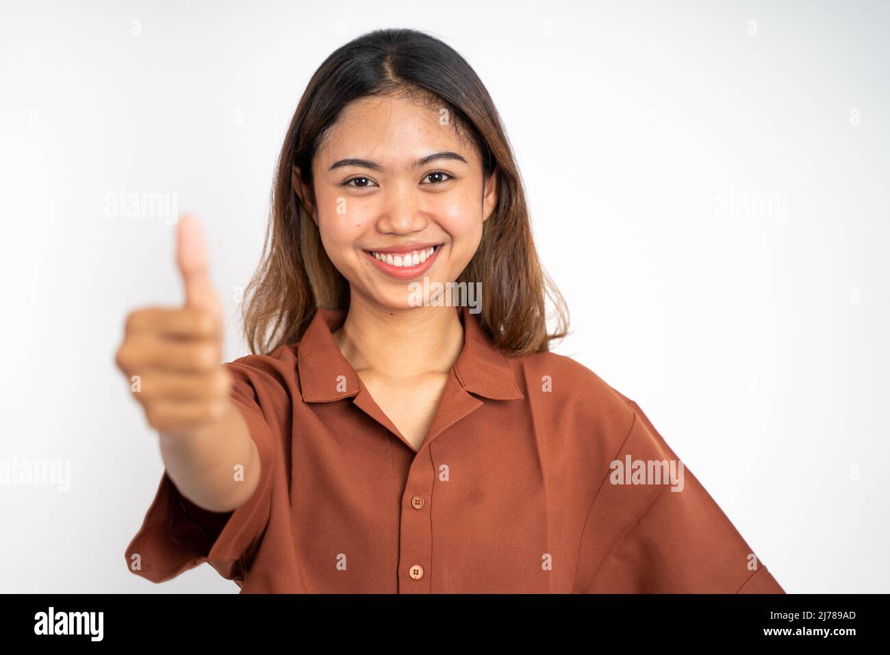 woman stand with thumbs up on isolated background Stock Photo - Alamy