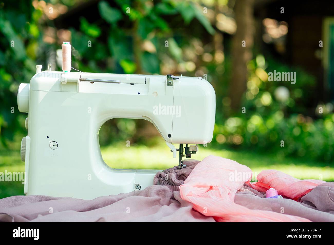 sewing machine outdoors in summer park against the background of the ...