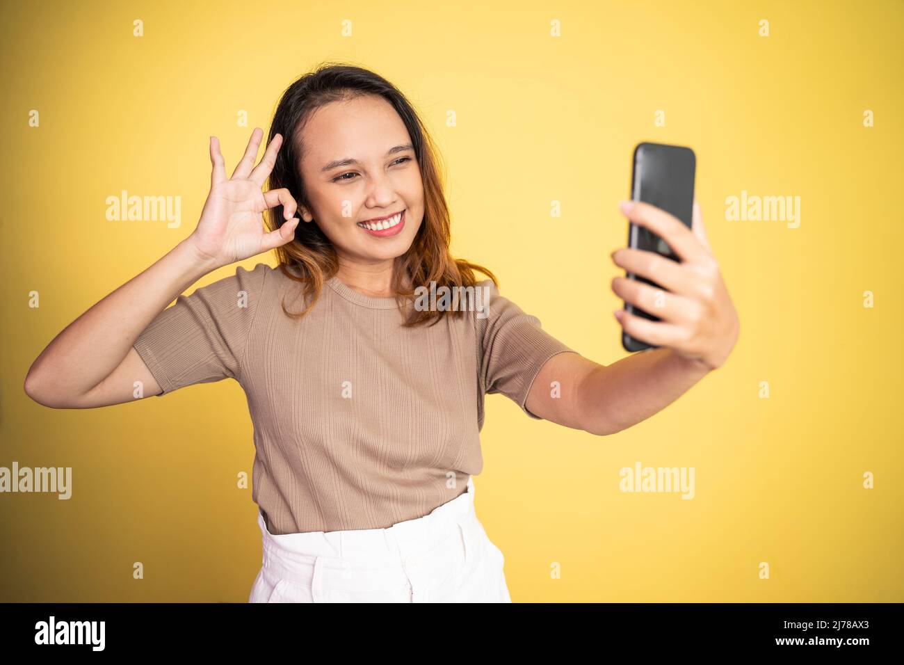woman take a selfie with ok hands gesture on isolated Stock Photo - Alamy