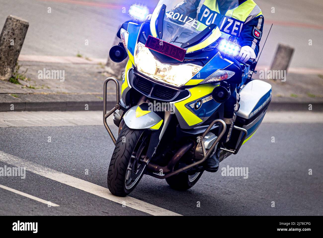 04 May 2022, Lower Saxony, Hanover: A police officer is driving a BMW ...
