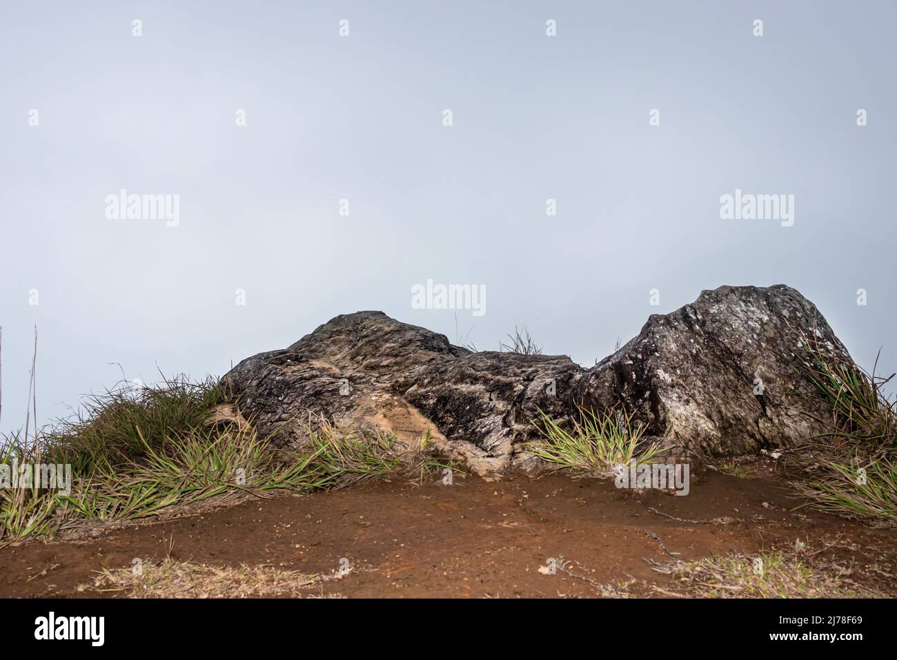isolated mountain rock with white mist background at morning from flat ...