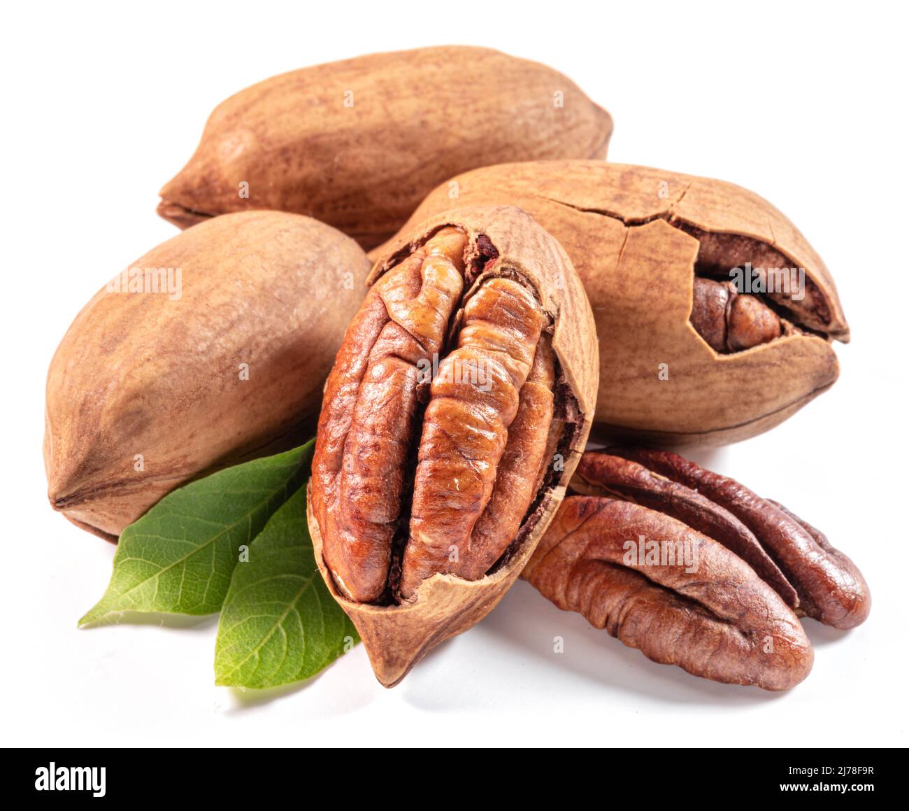 Shelled and cracked pecan nuts with leaves close-up on white background ...