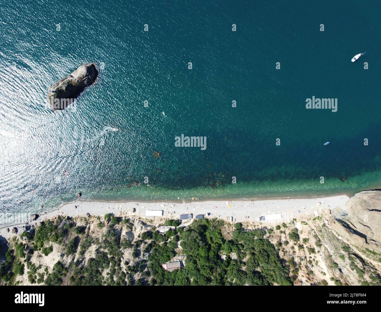 Aerial view from above on calm azure sea and volcanic rocky shores ...