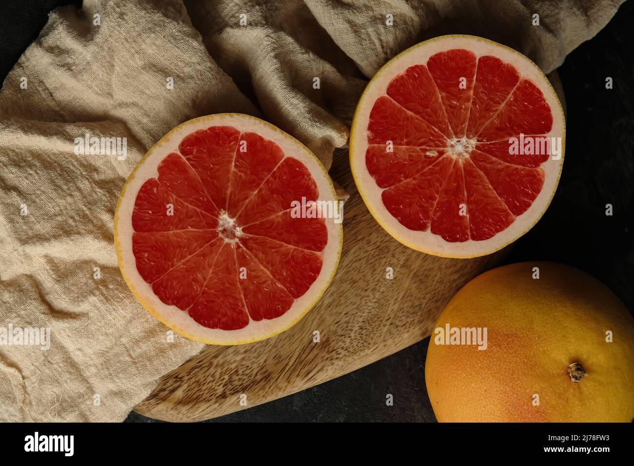 sliced ripe grapefruit on a light cloth Stock Photo - Alamy
