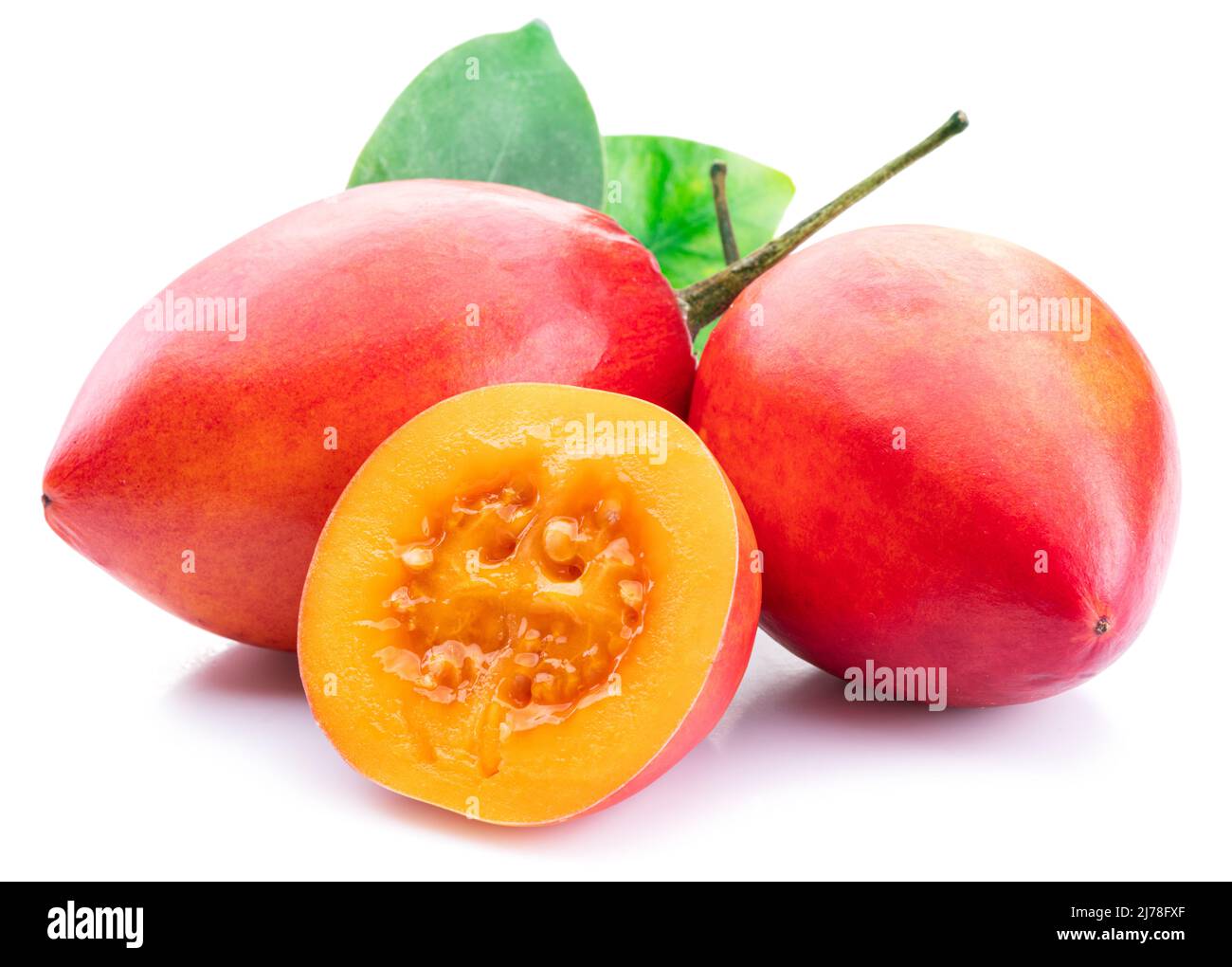 Ripe tamarillo fruits with slices and tamarillo leaves isolated on a ...