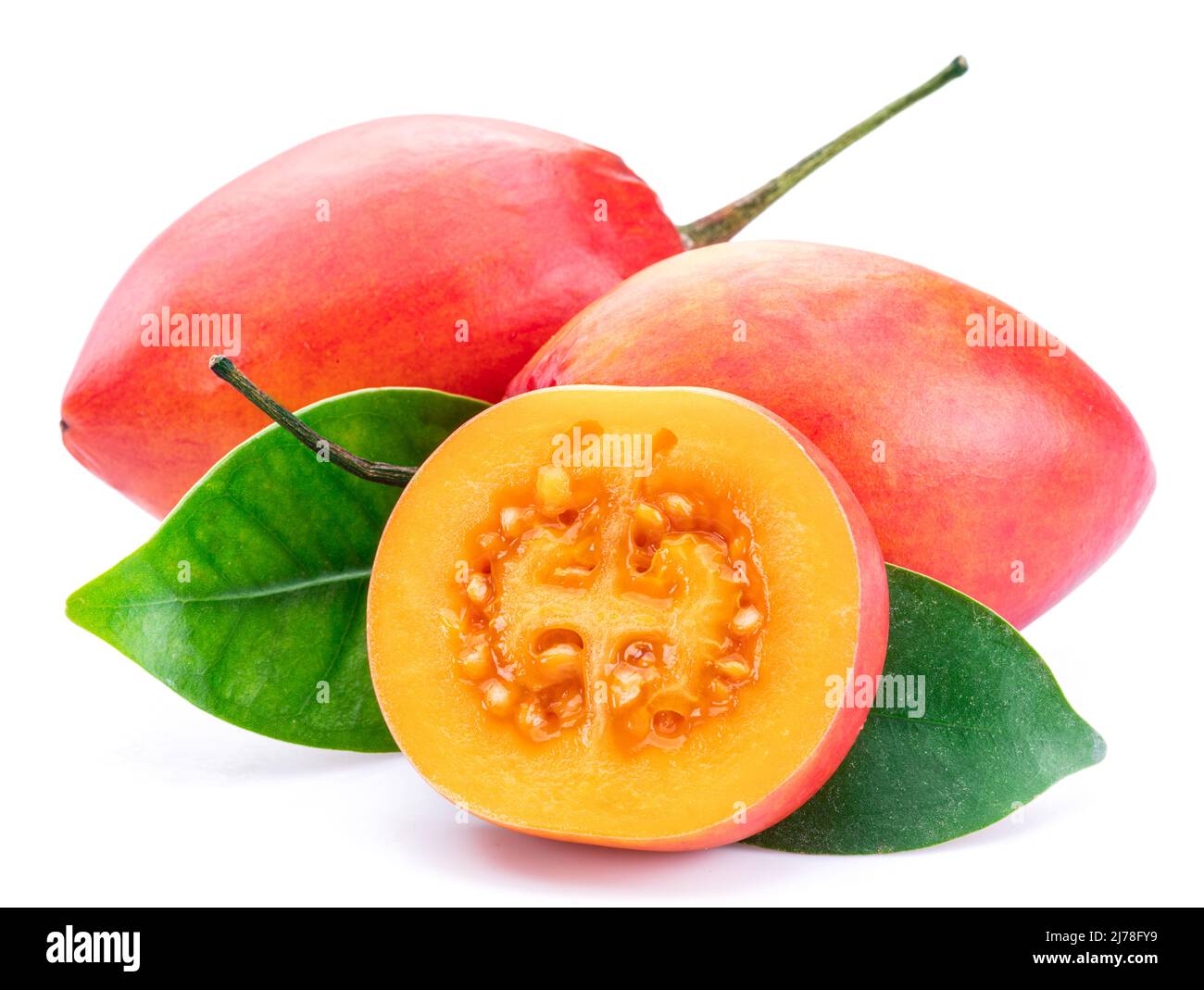 Ripe tamarillo fruits with slices and tamarillo leaves isolated on a ...